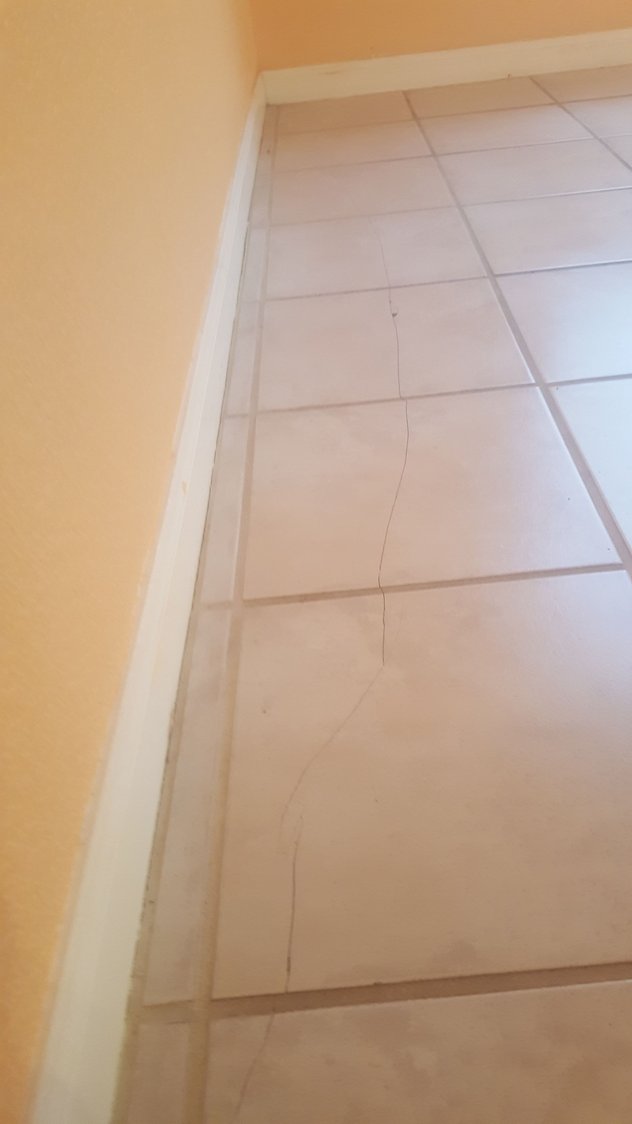 Cracked Tile in Living Room - DoItYourself.com Community Forums